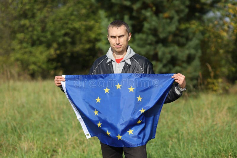 EU Flag in the Hands of a Man Stock Photo - Image of symbol, fabric ...