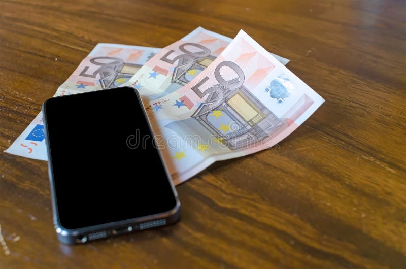 Euro Banknote and Smart Phone on Wood Table. Stock Photo - Image of ...