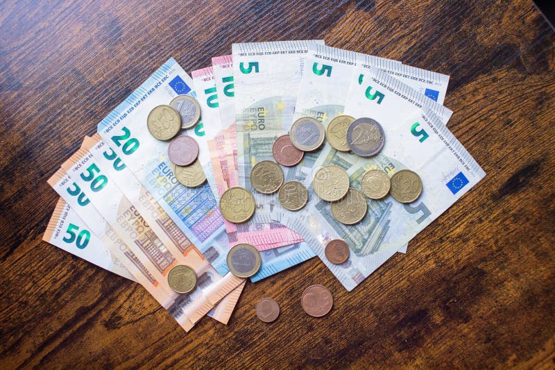 Euro Banknotes and Coins are Lying on a Wooden Table Stock Image ...
