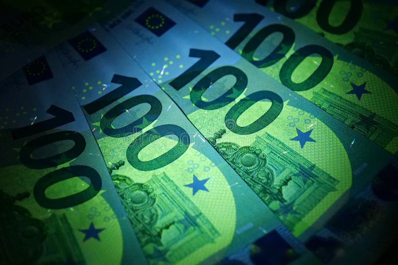100 Euro Banknotes Under UV Light. Security Signs and Elements on Euro ...