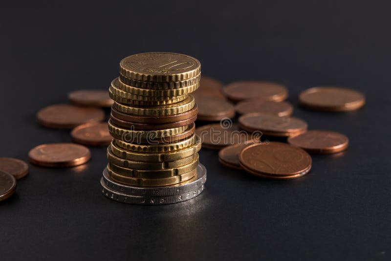 Euro and Euro Cent Coins on a Black Background. Stack of Coins Stock ...