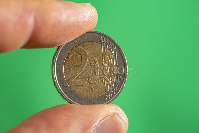 2 Euro Coin Face Held between Thumb and Index Finger. Stock Image ...