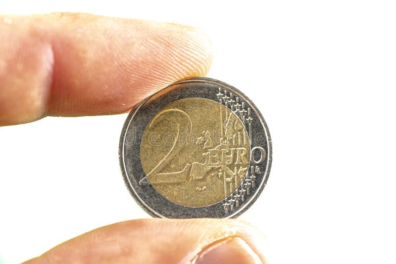 2 Euro Coin Face Held between Thumb and Index Finger. Stock Photo ...