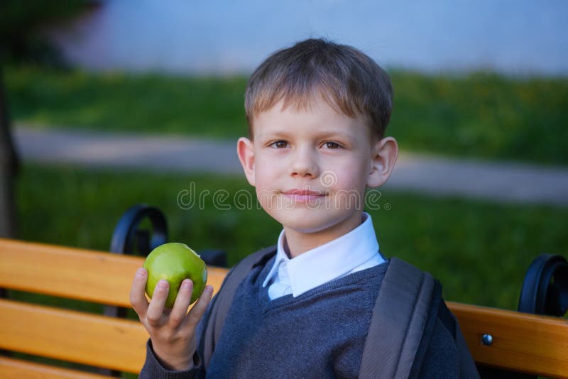European Boy Eats School Breakfast on the Park Bench Stock Image ...