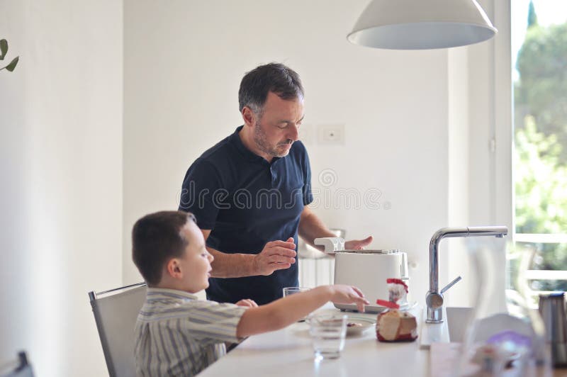 European Father and Son Making Breakfast in the Kitchen Stock Photo ...
