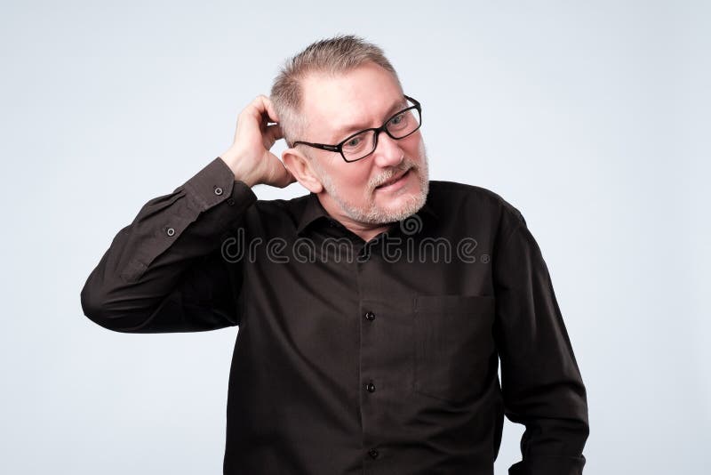 European Man Is Thinking About Something Scratching His Face With ...