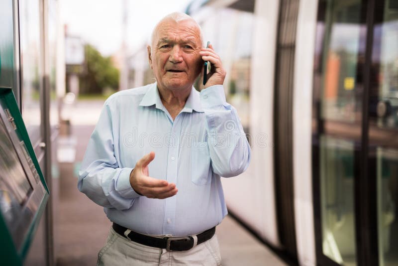 Old Man Talking on Phone in Tram Station Stock Photo - Image of ...
