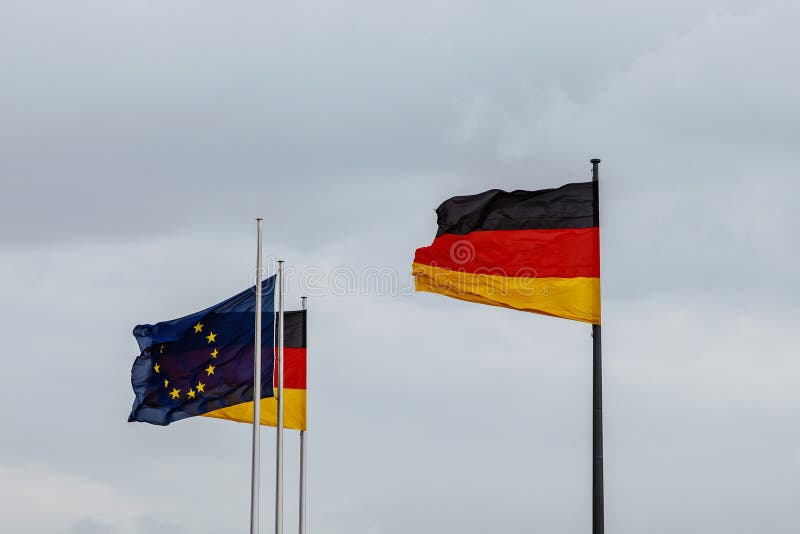 European Union and German Flags Fluttering Against a Cloudy Sky Stock ...