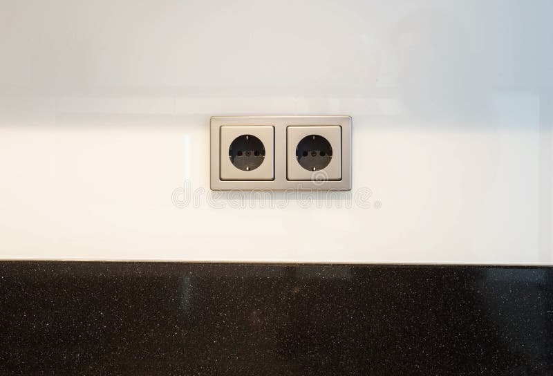 European White Electrical Outlet Socket and Black Cable Plugged in ...