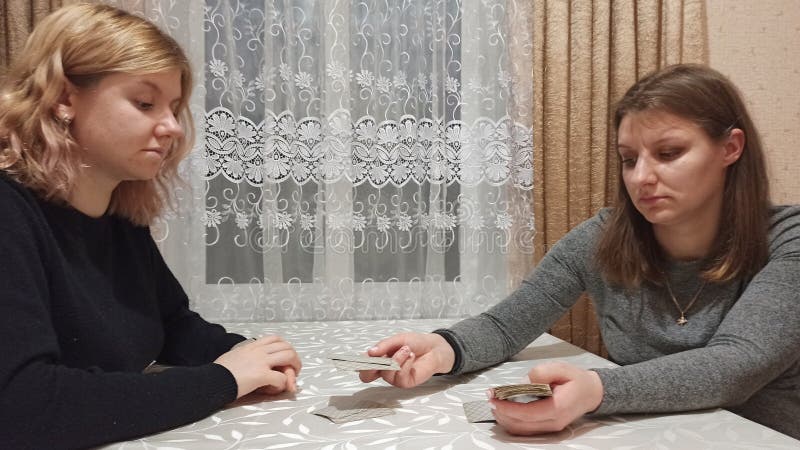 Women play cards at table stock image. Image of table - 188978795