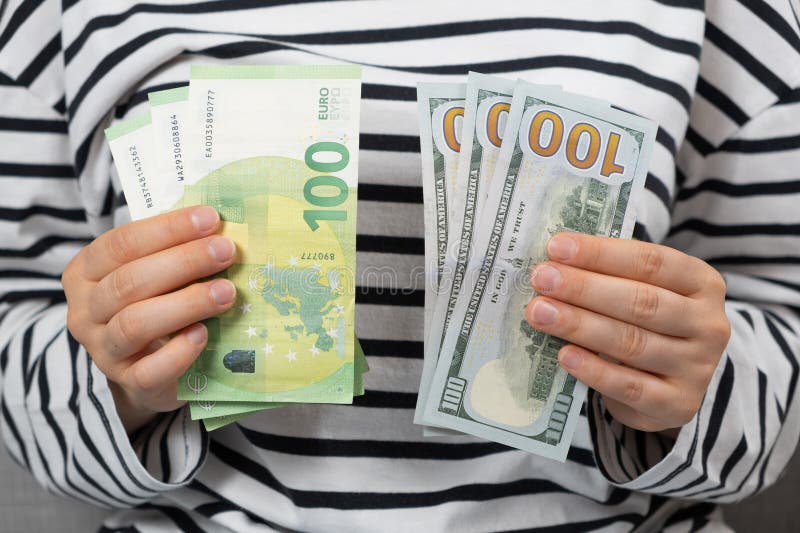 Euros and Dollars in the Hands of a Person, Different Currencies Stock ...