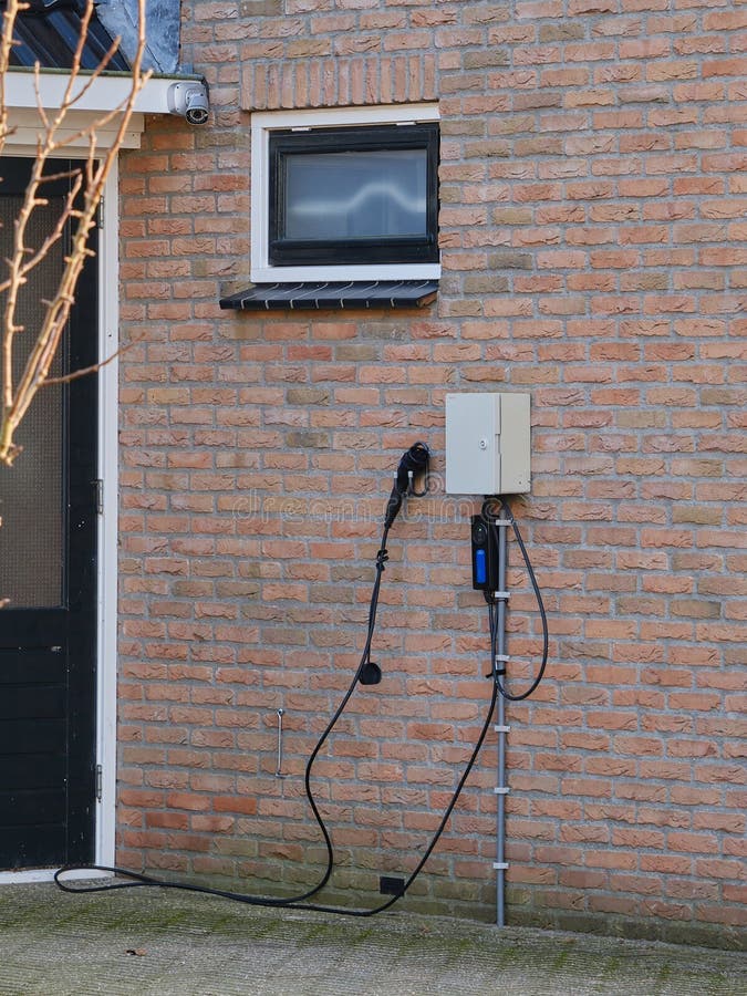 EV Charger on Brick Wall with Security Camera and Window View Stock ...