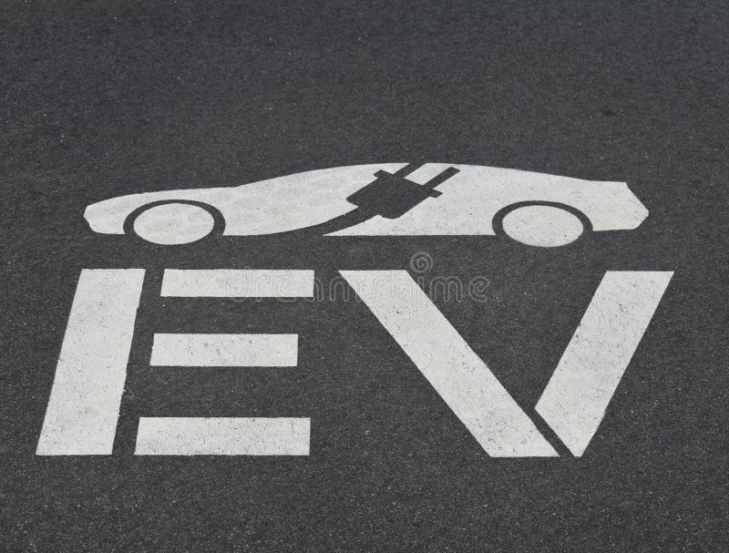 EV Electric Charging Logo on an Asphalt Parking Spot. Stock Image ...