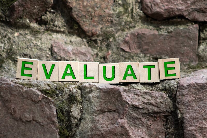 EVALUATE Word Written On Wood Block. EVALUATE Text On Wooden Table For ...