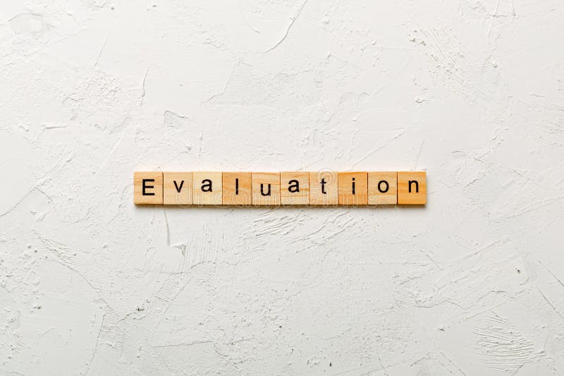 Evaluation Word Written on Wood Block. Evaluation Text on Table ...