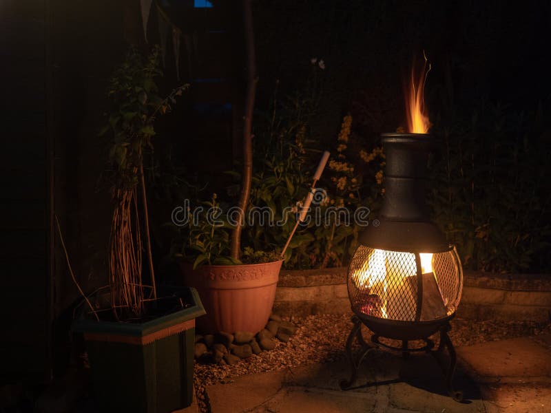Evening Around the Garden Chiminea Stock Image - Image of candle, flame ...