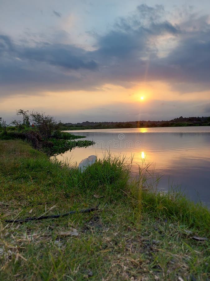 Evening Atmosphere with the Sun Setting on the Edge of the Lake Stock ...