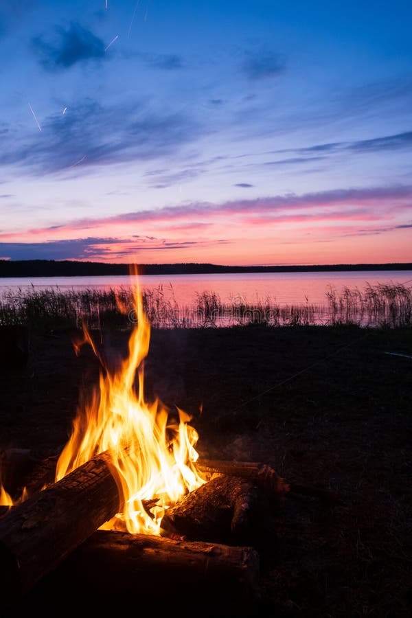 Evening Bonfire on the Lake and Sunset in the Sky Stock Photo - Image ...