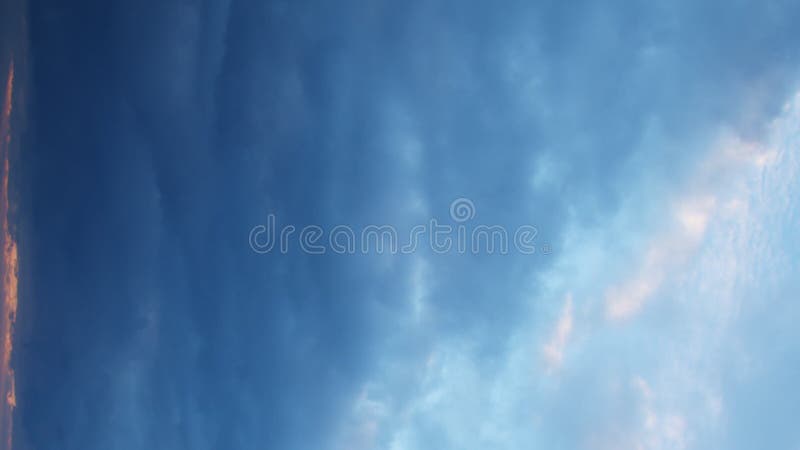 In the Evening, the Clouds Slowly Move Across the Dark Sky. the ...