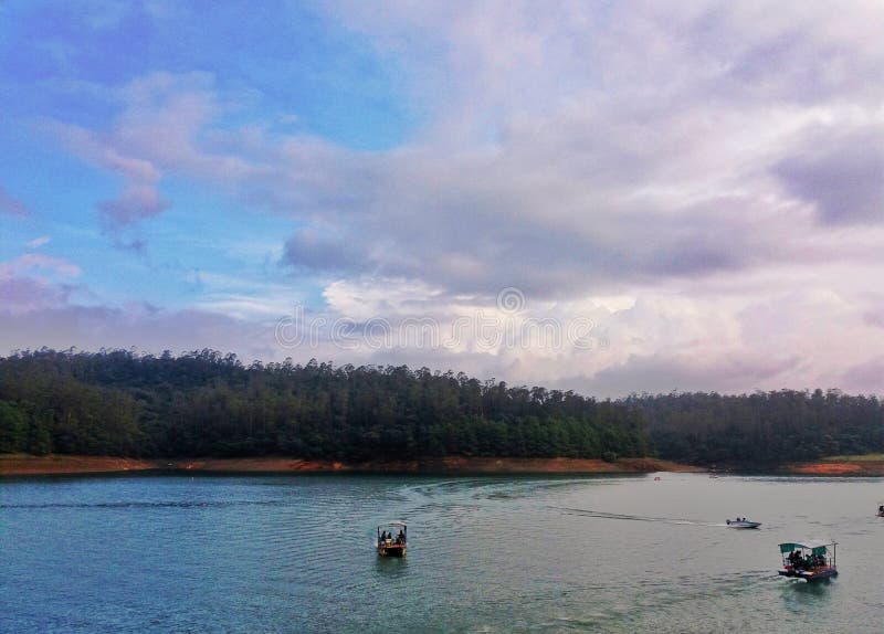 Evening lake boating scene stock image. Image of dusk - 142629215