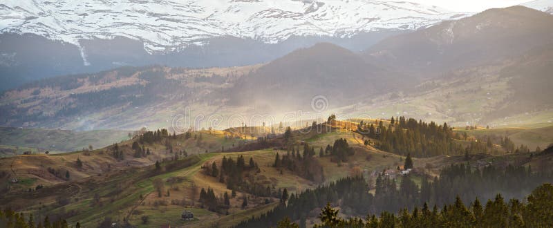 Evening Light in Spring Mountains. Snow and Green Fields Stock Photo ...
