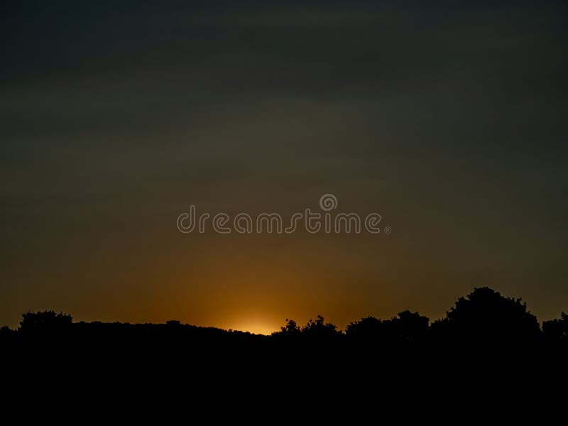 Sunset Behind Hills and Bushes Stock Photo - Image of dramatic, bushes ...