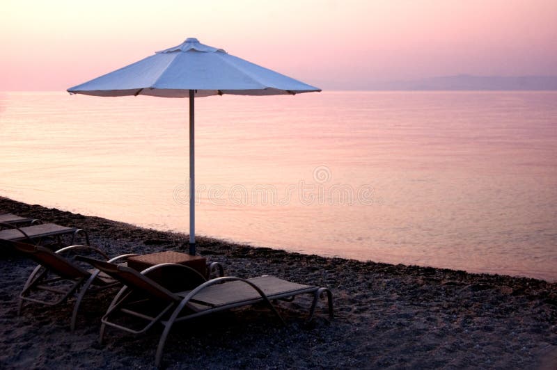 Evening sea and umbrella stock photo. Image of recreational - 5843918