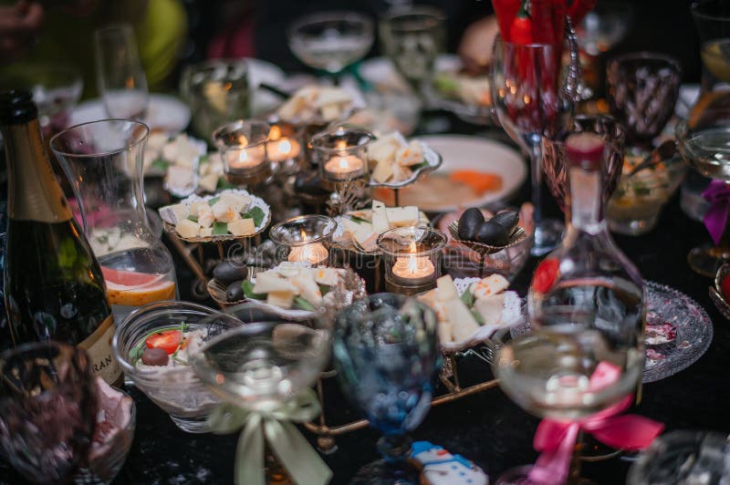 Evening Setting of a Party, Banquet. Table Laden with Many Dishes and ...