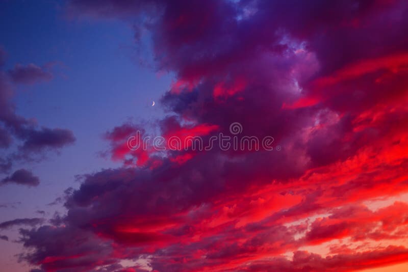Evening Sky with a Crescent Moon and Red and Purple Clouds. Stock Photo ...