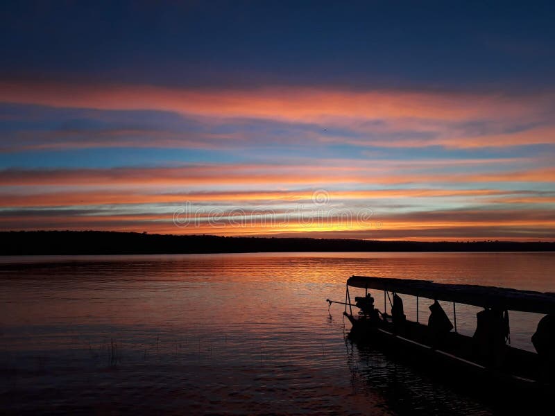Red Evening Sky by the Dam with a Boat Stock Photo - Image of horizon ...