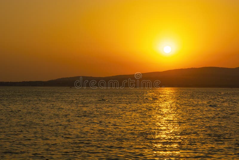 Evening Sky with the Setting Sun Over the Sea and Mountain. Spectacular ...