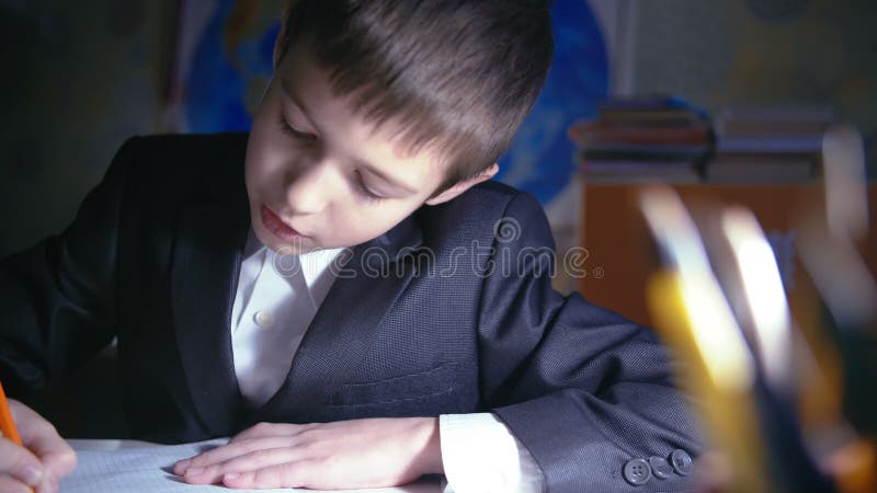 Evening Study Session: Boy Doing Homework, Writing Exercises in ...