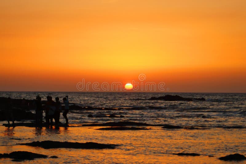 Evening Sunset on the Beach and Peoples Enjoy in the Ocean Waves Stock ...