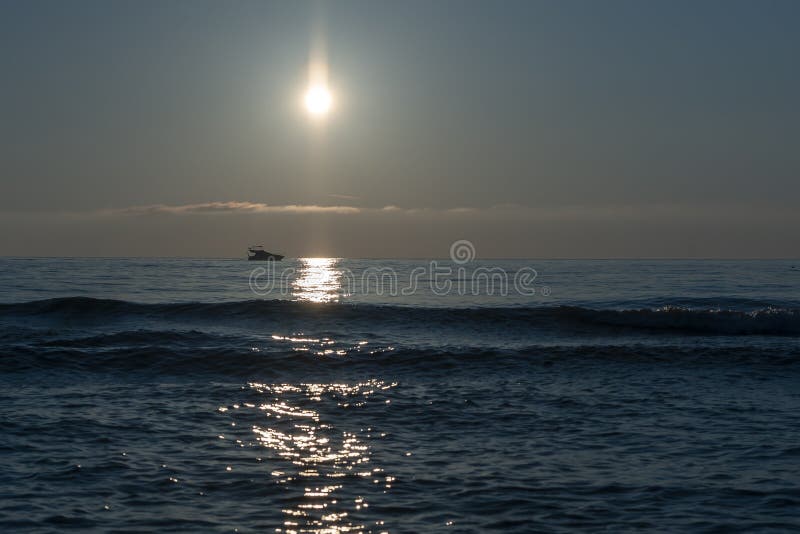 Evening Sunset Over the Sea with a Sea Boat Sailing on the Horizon ...