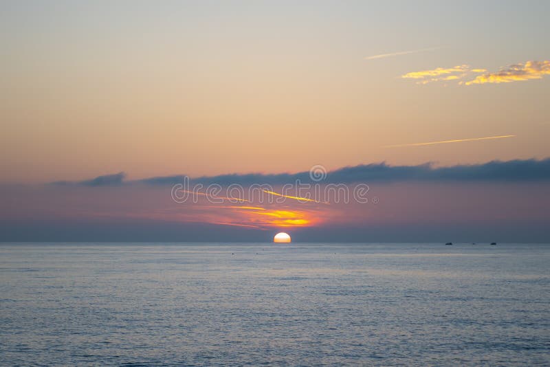 Evening Sunset Over the Sea on the Horizon among Rare Clouds. Stock ...