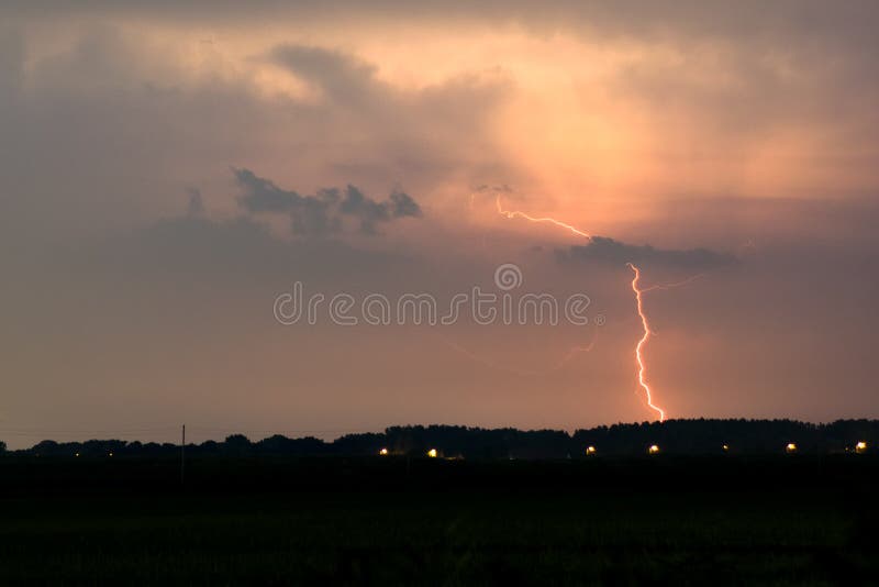 Red Colored Lightning Bolt Strikes from a Distant Thunderstorm Stock ...