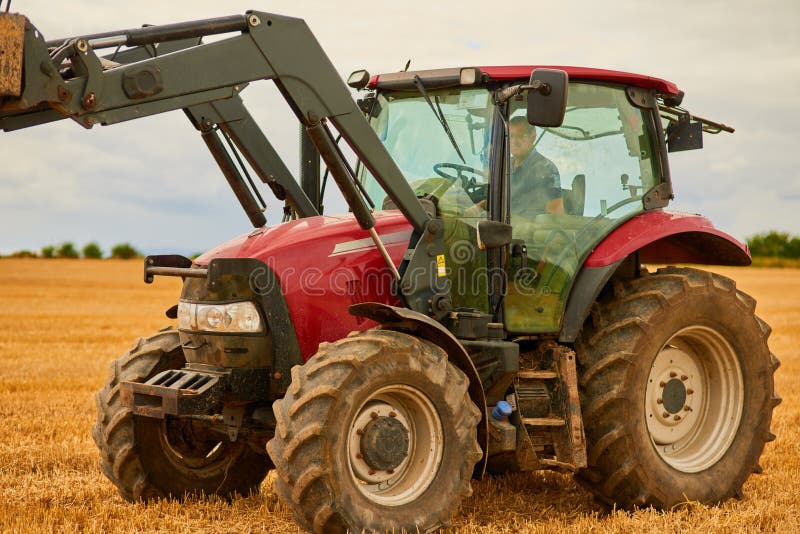Every Farm Needs a Tractor. a Farmer Driving a Tractor Around His Farm ...