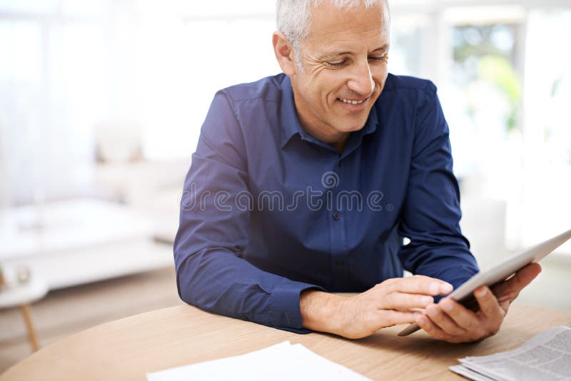 Everybody Loves a Good Meme. a Mature Man Using a Digital Tablet at ...