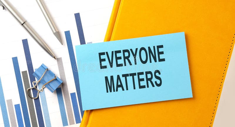 EVERYONE MATTERS Text on Sticker on the Yellow Notebook with Chart and ...
