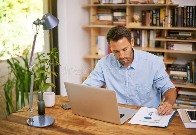 Almost Everything Rests on Paperwork. a Young Man Working from Home ...
