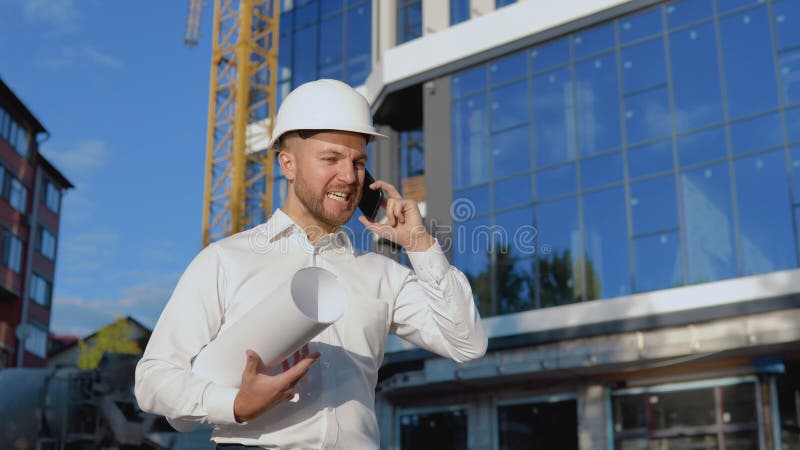 Evil Engineer in a White Shirt and Helmet Works on the Construction of ...