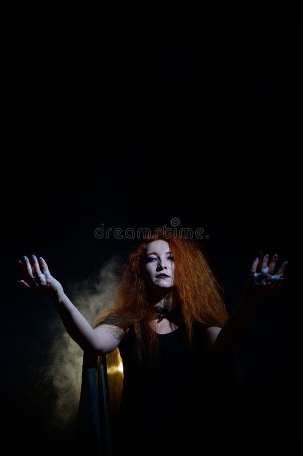 An Evil Red-haired Witch Holds Fire in Her Hands. Stock Photo - Image ...