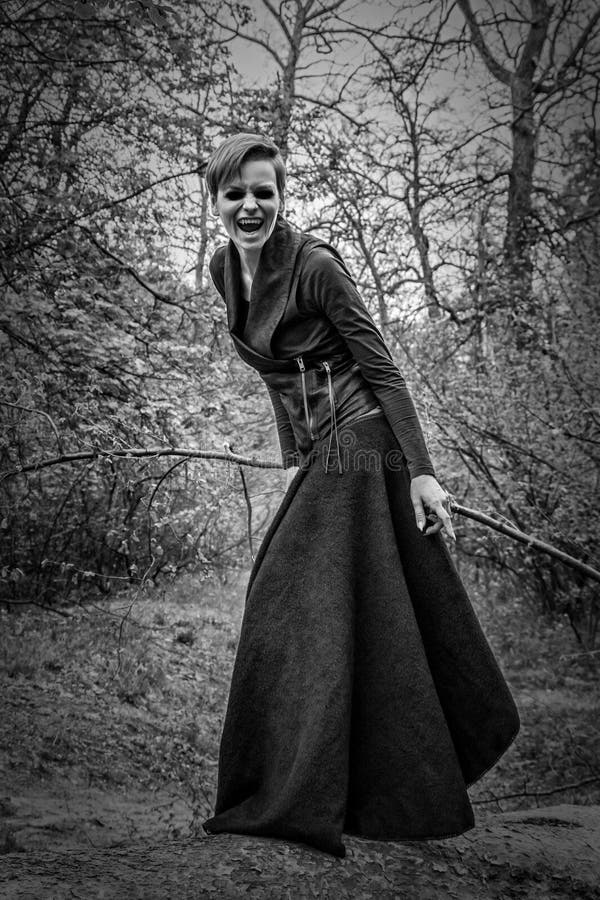 Evil Witch or Female Vampire, in the Forest, Bares Her Teeth ...
