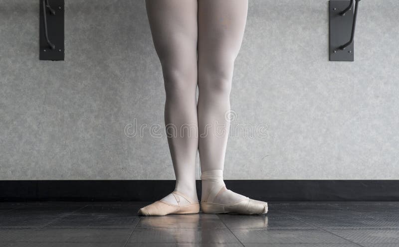 Ballet Dancer in First Position with One Foot in a Pointe Shoe, and One ...