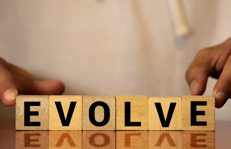 EVOLVE Word Written on Wood Block. EVOLVE Text on Wooden Table for Your ...