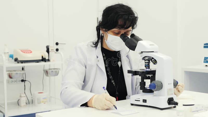 Examination through a Microscope of the Presence of Diseases. Stock ...