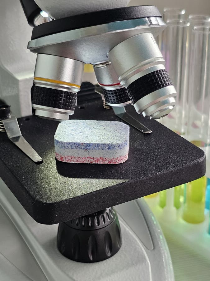 Examining a Colorful Tablet Under a Microscope in a Laboratory Stock ...