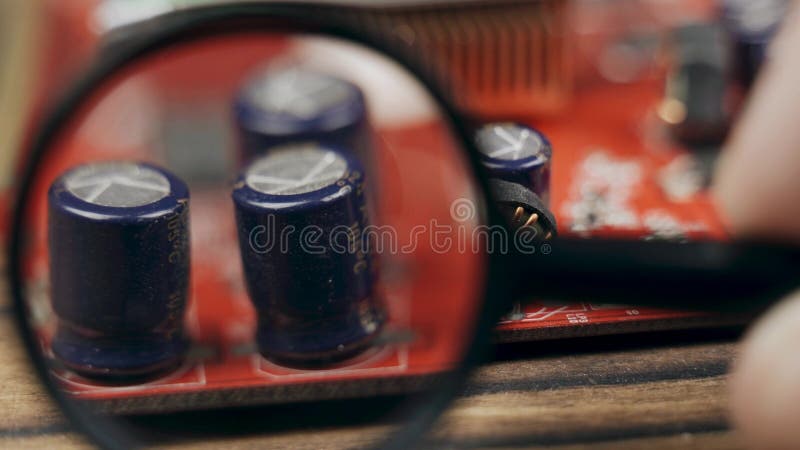 Examining the Details of an Electronic Board through a Magnifying Glass ...