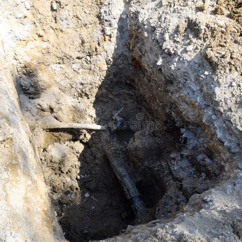 An Excavated Pit with a Damaged Pipeline. Repair of Stock Image - Image ...