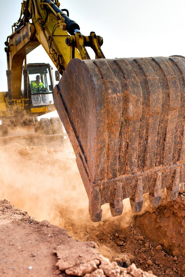 Backhoe Digging in Dust Close Up Stock Photo - Image of site, action ...